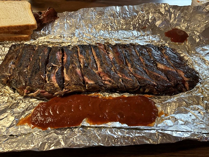 The bark on these ribs would make a lumberjack weep with joy. That perfect caramelization is the result of patience, smoke, and barbecue wisdom passed through generations.
