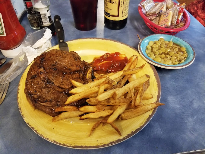A steak that commands its own zip code, served with fries that could make a Frenchman weep with joy.
