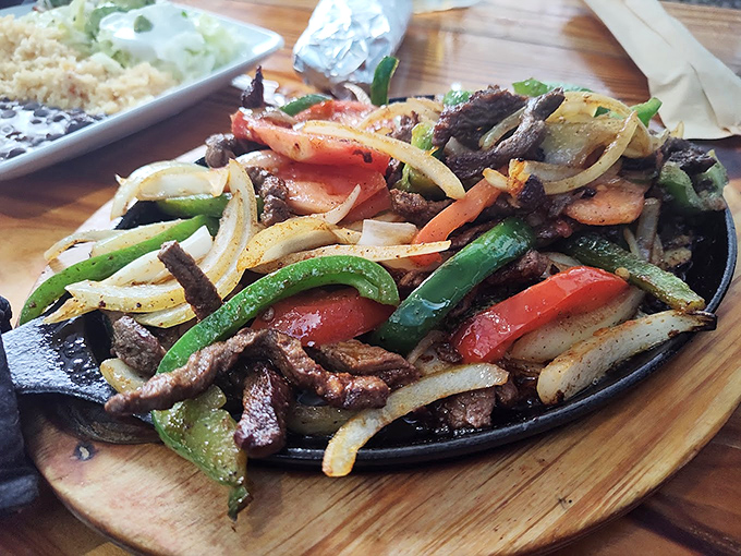 Steak fajitas served on a cast iron skillet hot enough to make vegetables dance and meat sing. The aroma alone is worth the trip.