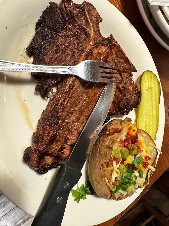 The knife slicing through this perfectly seared steak reveals the kitchen's commitment to getting the doneness just right, every time.