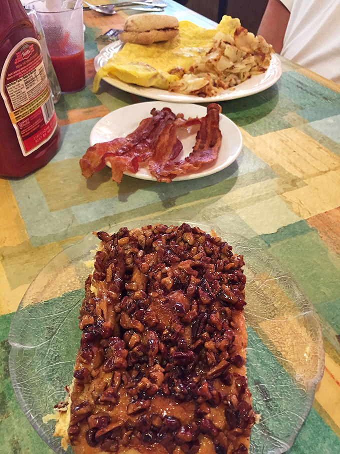 The holy trinity of breakfast bliss: a sticky bun that could make angels weep, perfectly crisped bacon, and an omelet that puts hotel buffets to shame.