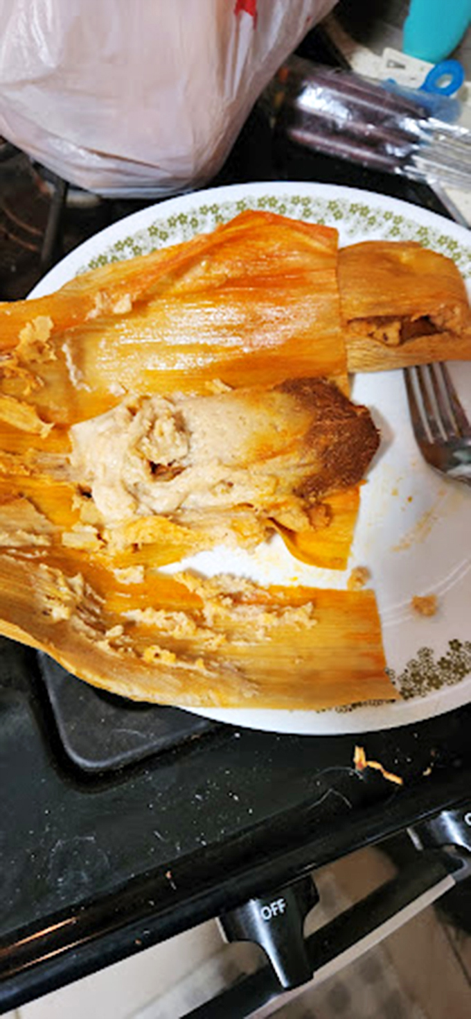 Behold the tamale in its natural habitat: corn husk parted to reveal the treasure within. This is edible gift-wrapping at its finest.