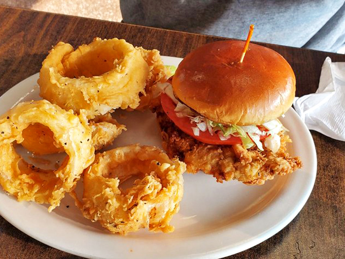 The breaded tenderloin sandwich&mdash;Indiana's unofficial state food&mdash;spilling gloriously beyond its bun boundaries with crispy, golden-fried defiance.