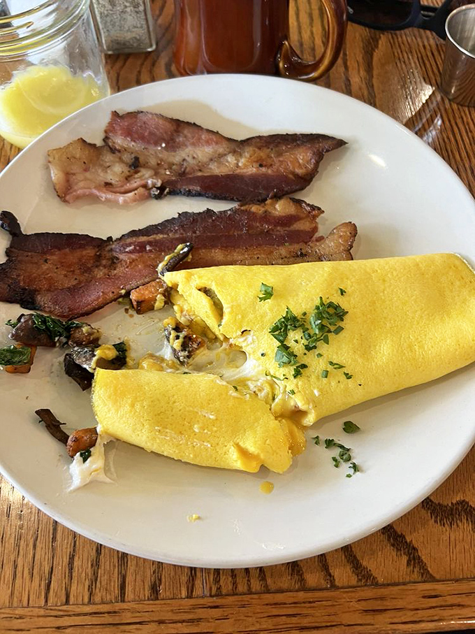 That omelet isn't just yellow&mdash;it's sunshine on a plate. Paired with bacon that's achieved that mythical balance between crisp and tender.