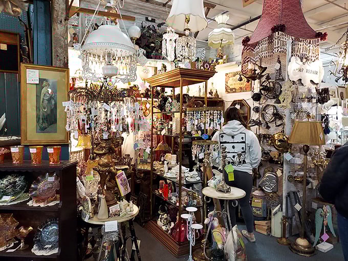Treasure hunters navigate through a sparkling forest of chandeliers and vintage decor, where one person's former possessions become another's newfound joy.
