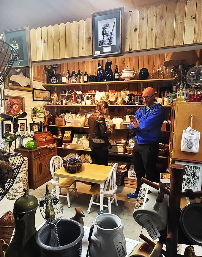 Shoppers examine glassware with the focused concentration of archaeologists, each hunting for that perfect piece to complete their collection.