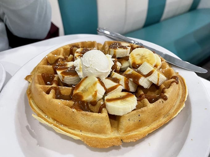 This isn't just a waffle&mdash;it's architecture with syrup. Bananas and ice cream transform breakfast into dessert, and nobody's complaining about it.