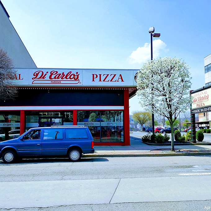  DiCarlo's bold red storefront stands out like a pizza lighthouse, guiding hungry souls toward Ohio Valley-style salvation.