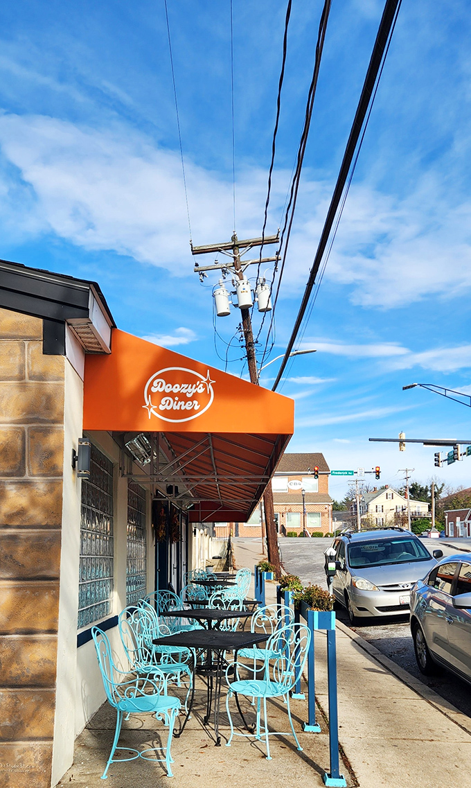 Doozy's vibrant orange awning and turquoise patio furniture create the perfect stage for your breakfast theater performance.