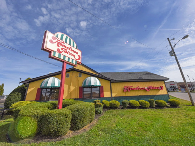 Hometown Pizza's cheerful yellow exterior is like a smile before the first bite.