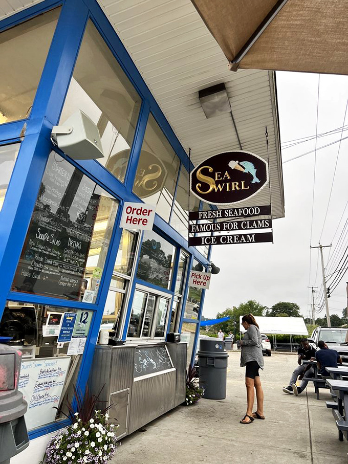 Sea Swirl's blue-trimmed order window promises three essential food groups: seafood, clams, and ice cream—the trinity of summer happiness.