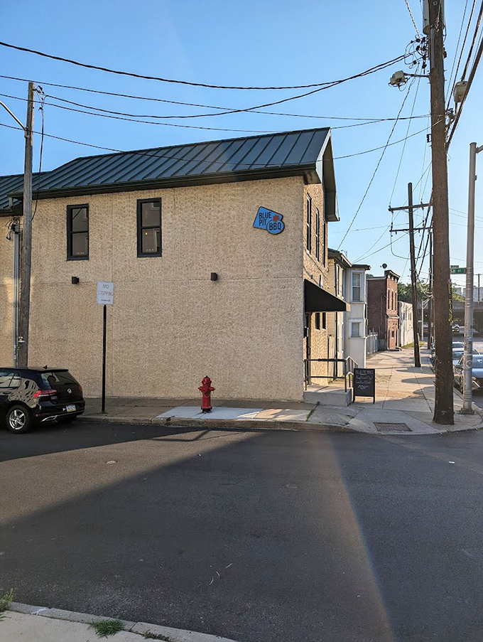 Blue Pit BBQ: The blue sign against that stone building is like a beacon for BBQ pilgrims seeking smoky salvation.