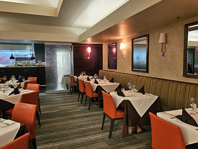 Orange chairs and white tablecloths: the perfect canvas for the edible art that's about to arrive.