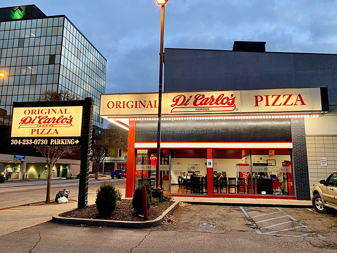  At night, DiCarlo's illuminated sign becomes a beacon of hope for those seeking the unique joy of room-temperature cheese on hot crust.