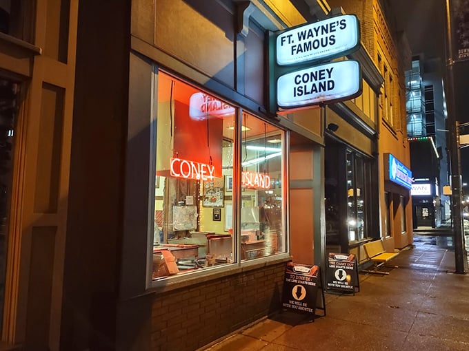 Night falls but hunger rises at Fort Wayne's Famous Coney Island, where that glowing neon window promises late-night salvation.