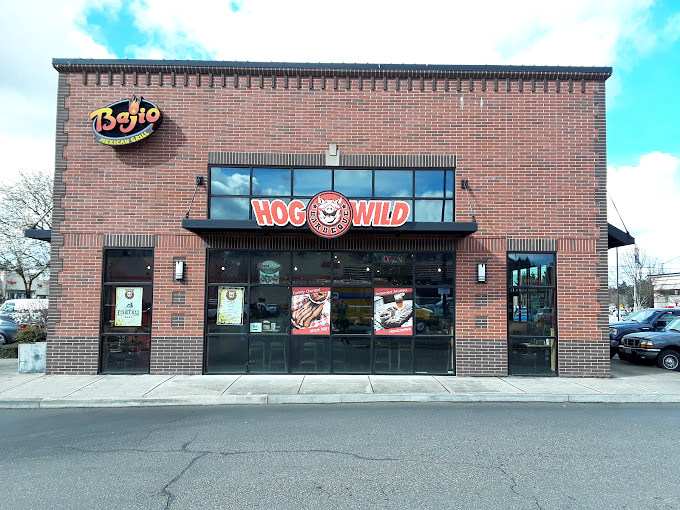 That grinning pig logo knows something you don't yet - you're about to have a religious experience with pulled pork.