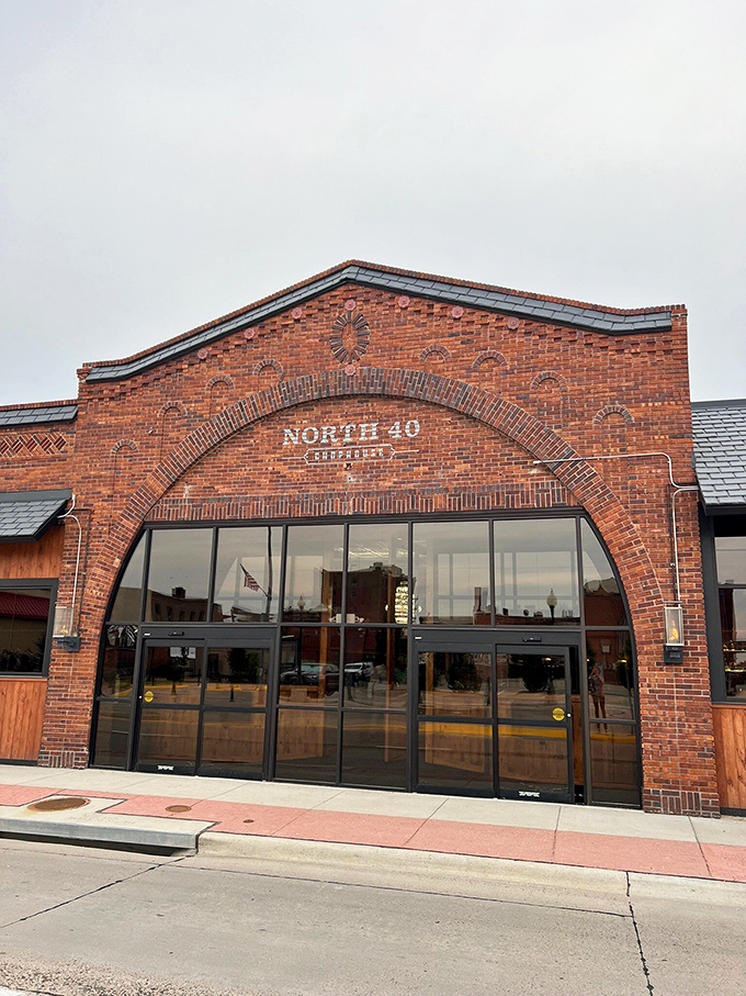 Morning light catches North 40's distinctive curved brick facade, a modern steakhouse that honors Nebraska's beef heritage with style.