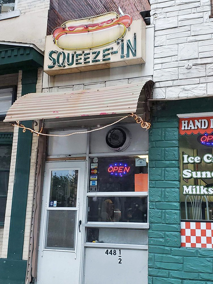 Since 1945, this little turquoise time machine has been serving up dogs worth squeezing in for – classic Americana with every bite.