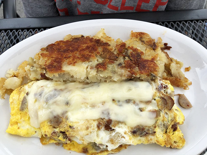 Breakfast architecture at its finest&mdash;golden eggs supporting a perfect cheese roof. Those home fries deserve their own fan club.
