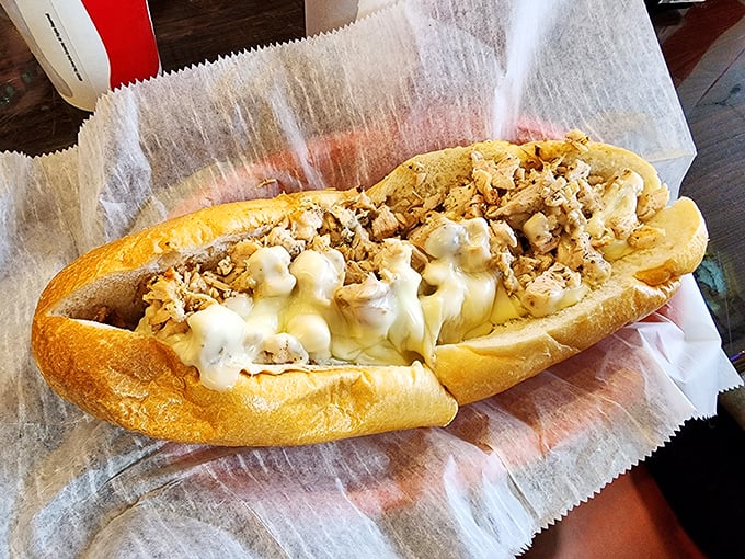 Melted cheese cascades over tender chicken, creating the kind of sandwich that makes you temporarily forget how to blink. Pure sandwich hypnosis.