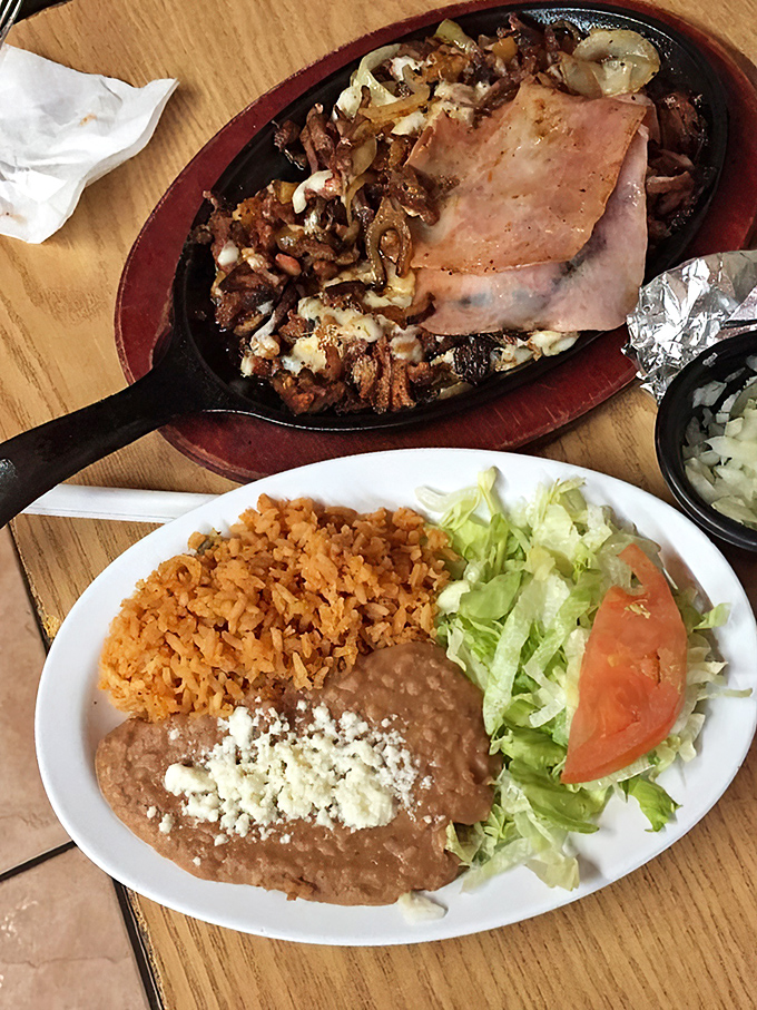 Sizzling fajitas that announce their arrival before you see them. That ham slice is the unexpected supporting actor in this delicious culinary drama.