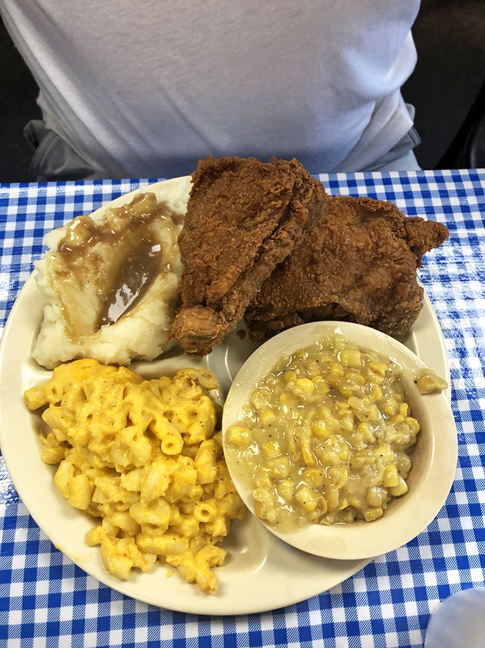 Mac and cheese that could make a grown man weep, mashed potatoes swimming in gravy, and chicken that defies physics with its perfect crunch.