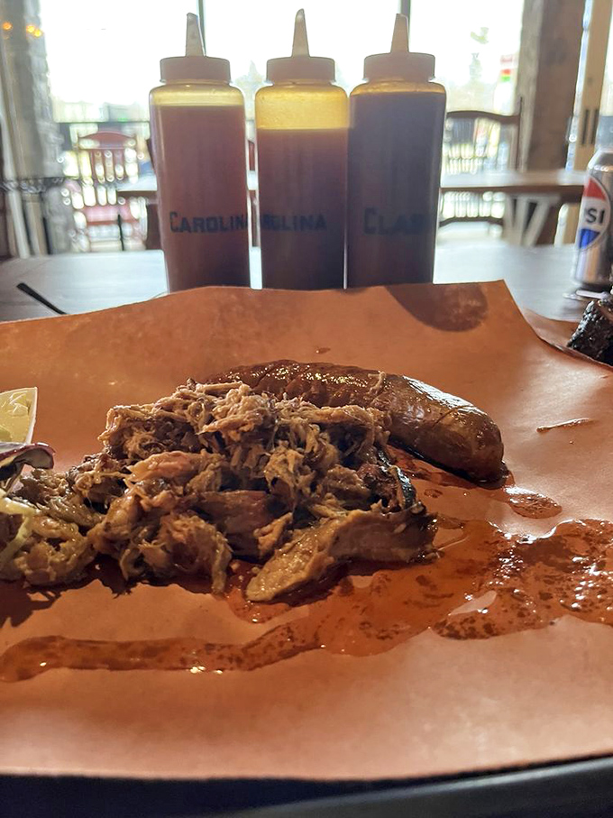 Three sauce bottles stand at attention like barbecue soldiers, ready to enhance meat that honestly doesn't need their help.