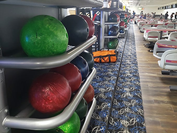A rainbow of bowling balls awaits their moment of glory, each one promising the possibility of that elusive perfect game.