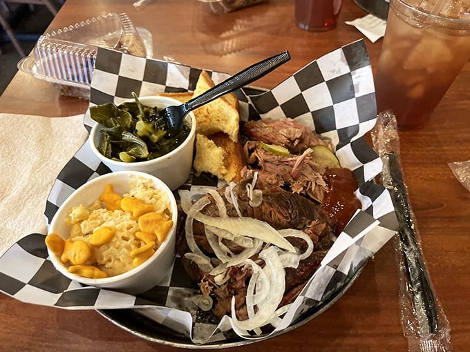 Brisket with that telltale smoke ring sitting alongside mac and cheese and collard greens. This plate doesn't just feed you&mdash;it hugs your soul.