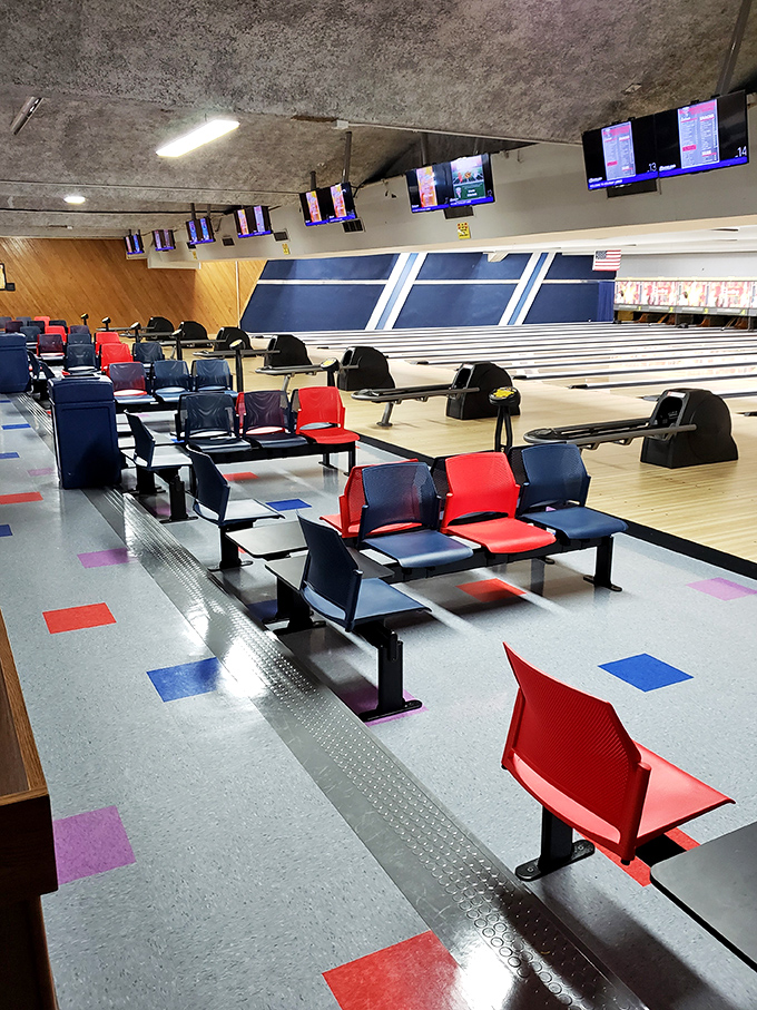 The red and blue seating arrangement isn't just functional&mdash;it's a splash of primary-colored comfort where triumph and gutter-ball despair are equally accommodated.