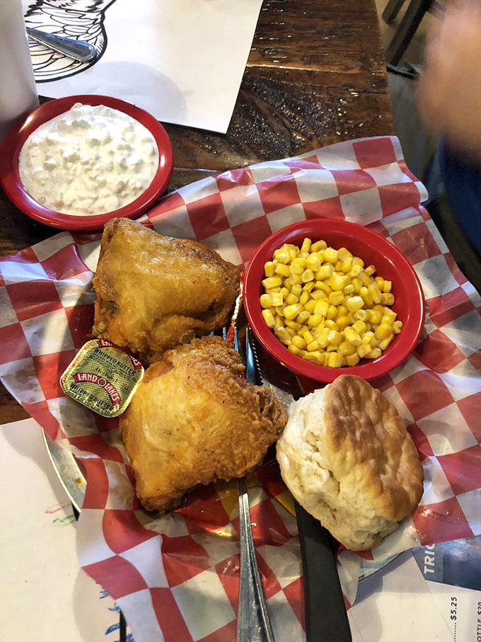 Southern hospitality on a plate: golden fried chicken, buttery corn, and a biscuit that would make your grandmother both jealous and proud.