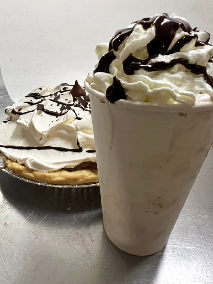 The perfect pairing: a slice of heaven alongside a tall glass of cloud-like bliss, both drizzled with chocolate ambition.