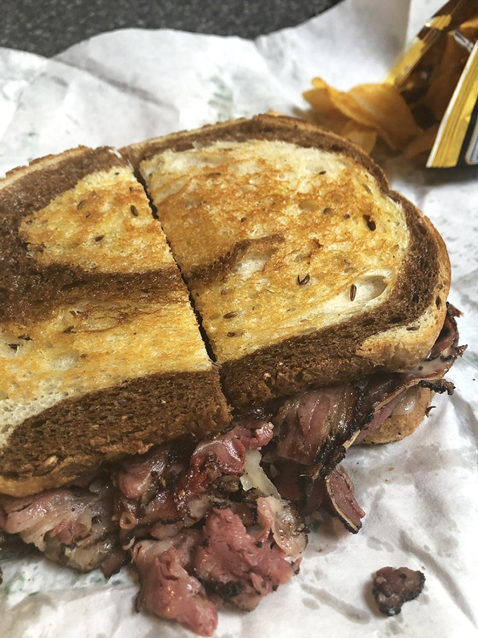Golden-brown rye reveals the succulent corned beef within. That cheese pull is what sandwich fantasies are made of.