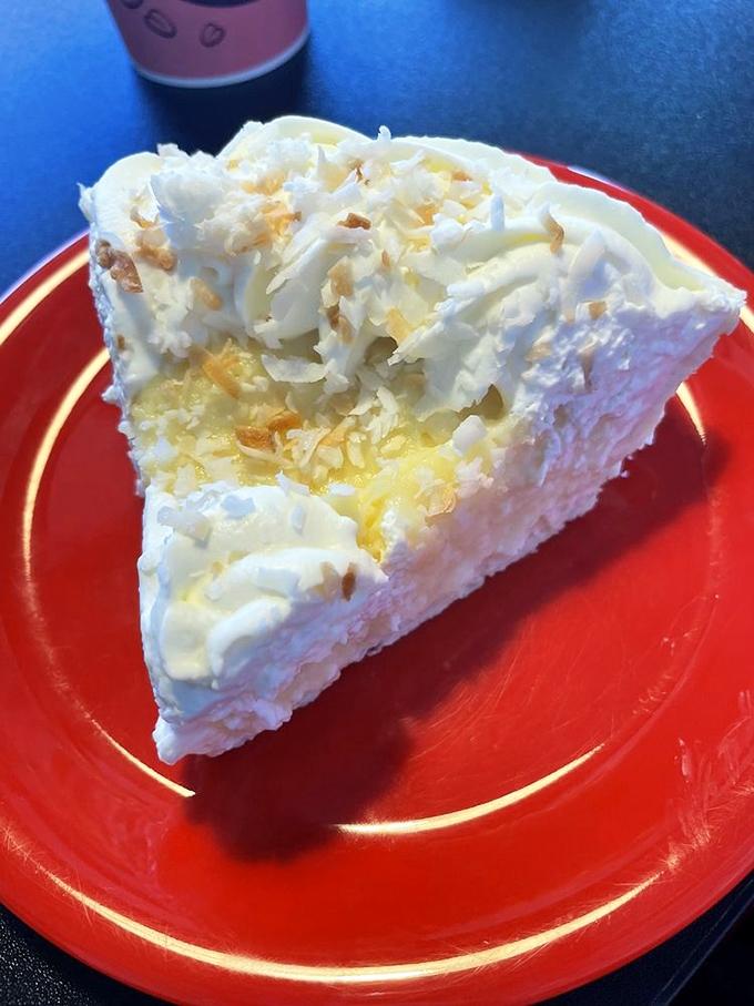 Coconut cream pie so tall it needs its own area code. That mountain of toasted coconut flakes isn't just decoration – it's commitment.