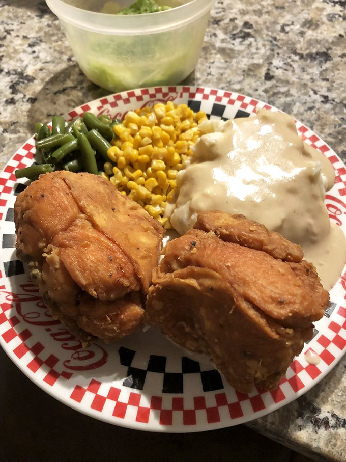 The holy trinity of Midwestern comfort: golden fried chicken, sweet corn, and mashed potatoes swimming in gravy. Diets beware.