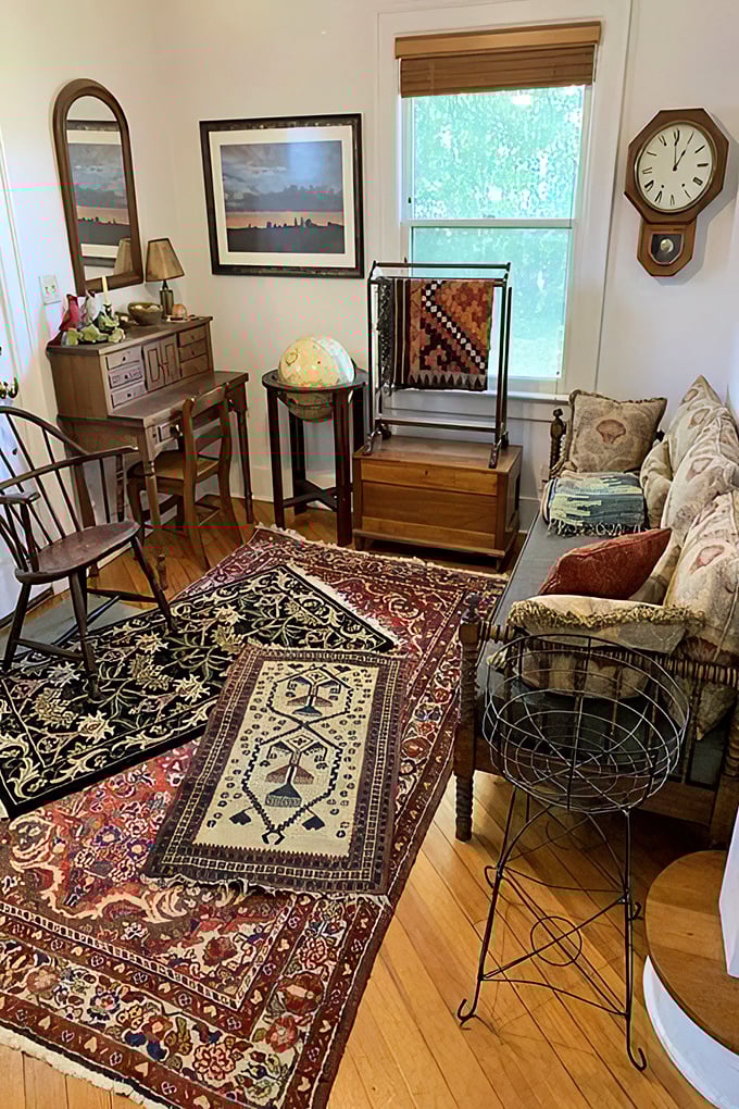 A perfectly staged vignette of vintage living. Those layered Persian rugs and Windsor chair would make any mid-century modern enthusiast swoon.