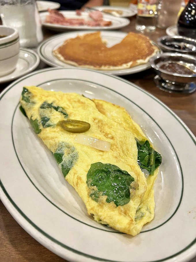 The jalape&ntilde;o spinach omelet brings just enough heat to wake you up, while that golden pancake in the background patiently waits its turn.