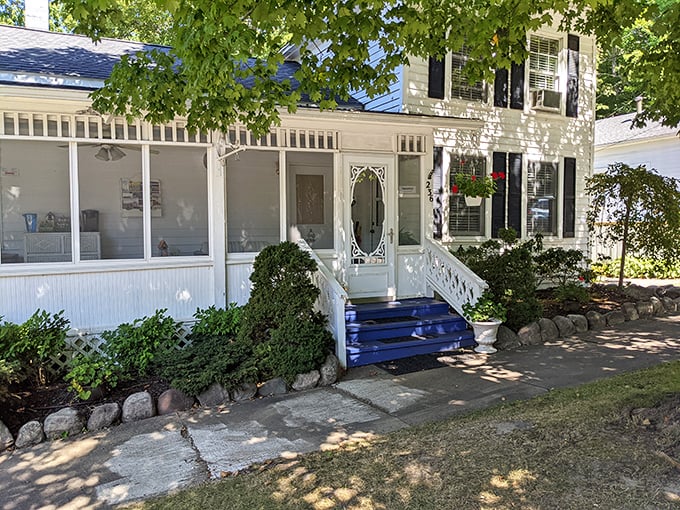 This picture-perfect porch belongs on a greeting card—the quintessential Michigan summer retreat where screen doors still slam and lemonade is always in season.