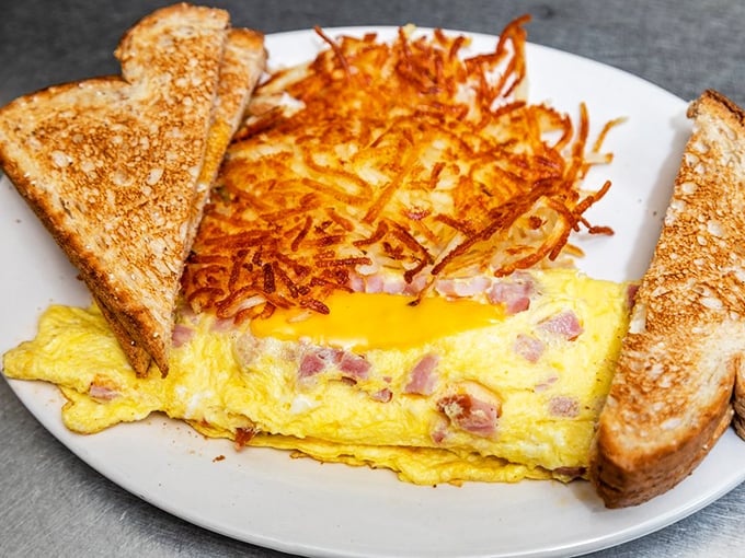 This ham and cheese omelet with crispy hash browns isn't just breakfast&mdash;it's edible therapy that costs less than a session with your therapist.
