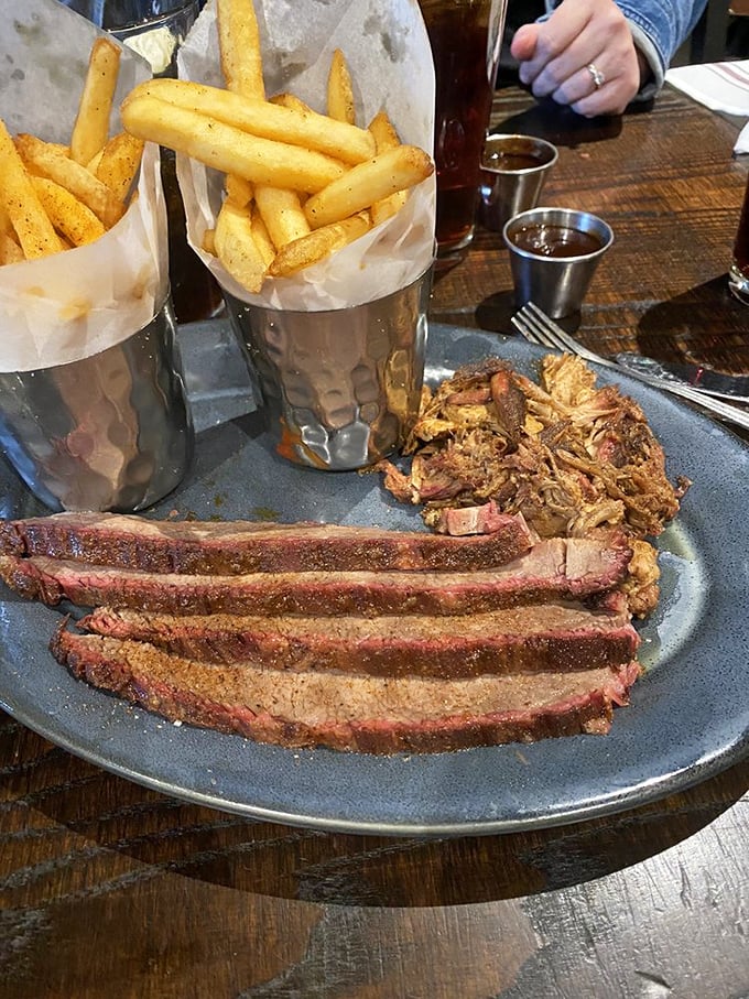 Brisket with that perfect pink smoke ring alongside pulled pork&mdash;proof that sometimes the hardest choices in life are the most delicious ones.