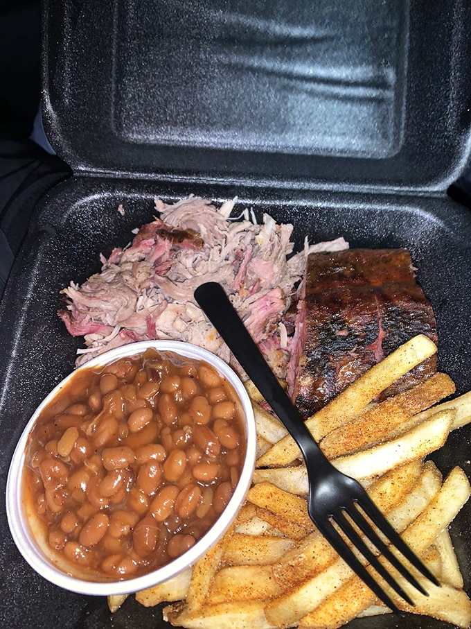 The holy trinity of Southern comfort: pulled pork with perfect bark, beans simmered to perfection, and fries that don't pretend to be anything fancy.