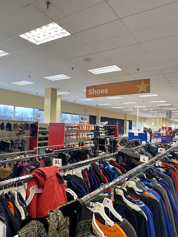 Under the bright orange "Shoes" sign, rows of footwear stand at attention, waiting for their Cinderella moment with new owners.