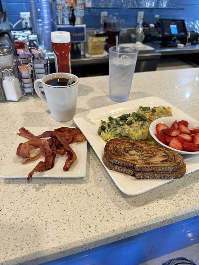 A breakfast trinity that would make any morning deity proud: perfectly scrambled eggs, home fries with attitude, and toast ready for its close-up.