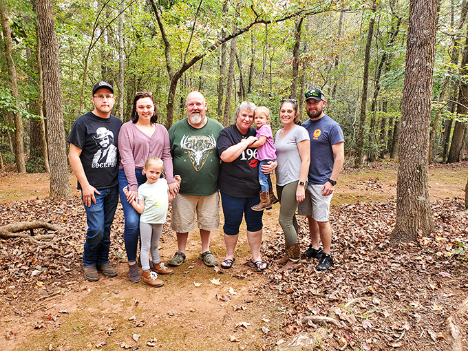 Family memories being made in real time. Generations gathering beneath the canopy of trees, creating stories that will outlast any social media post.