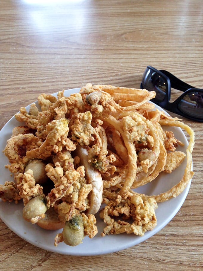 Seafood architecture at its finest. The structural integrity of those onion rings supporting the mountain of clams deserves an engineering award.