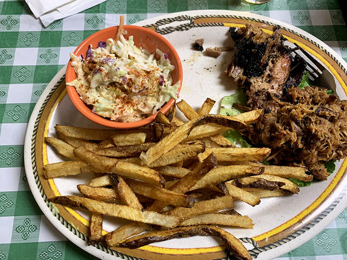 Pulled pork perfection! This sandwich is piled so high, it's like a delicious game of Jenga waiting to be devoured.