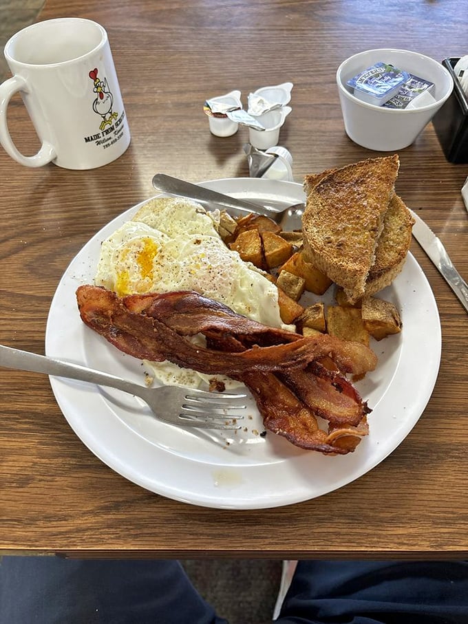 The classic breakfast trinity: eggs with that perfect runny yolk, bacon cooked to that magical crisp-yet-chewy state, and toast for sopping up every last bit.