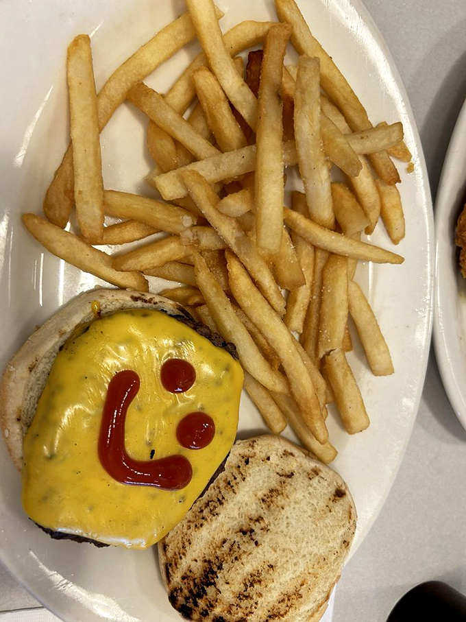 The chef's sense of humor shines through with a ketchup smile—proving that at Charcoal Pit, they play with their food so you can too.