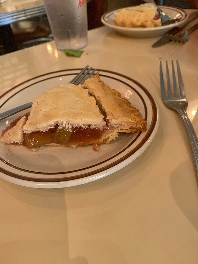 The apple pie glistens with that perfect balance of sweet and tart—the kind that makes you wonder if you should share or fake a sudden need for privacy.