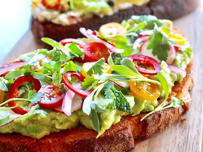 Avocado toast that's worth every penny of your down payment. This vibrant masterpiece proves LA knows how to elevate simple ingredients.